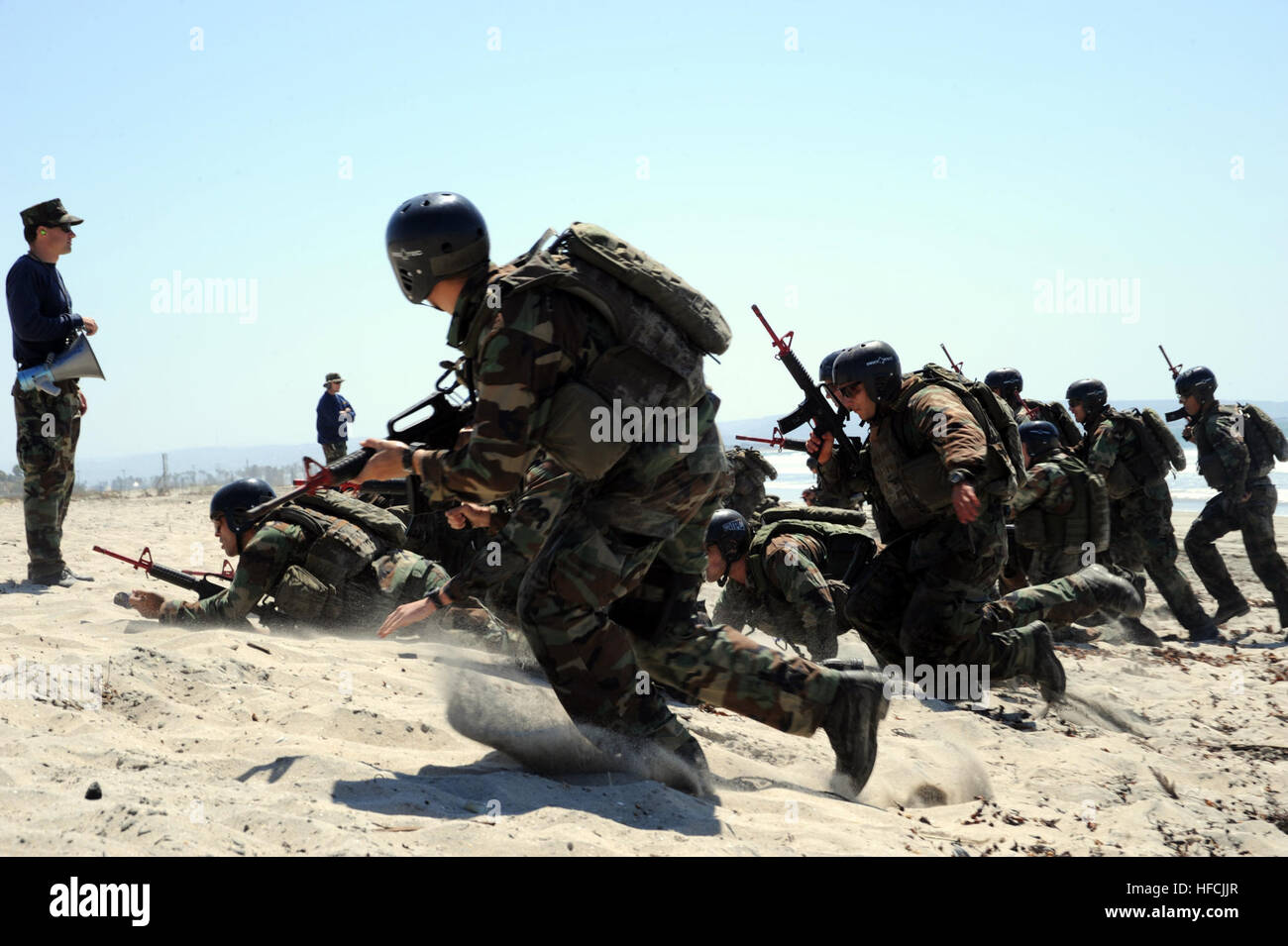 Crewman Qualification Training students charge the beach during a ...