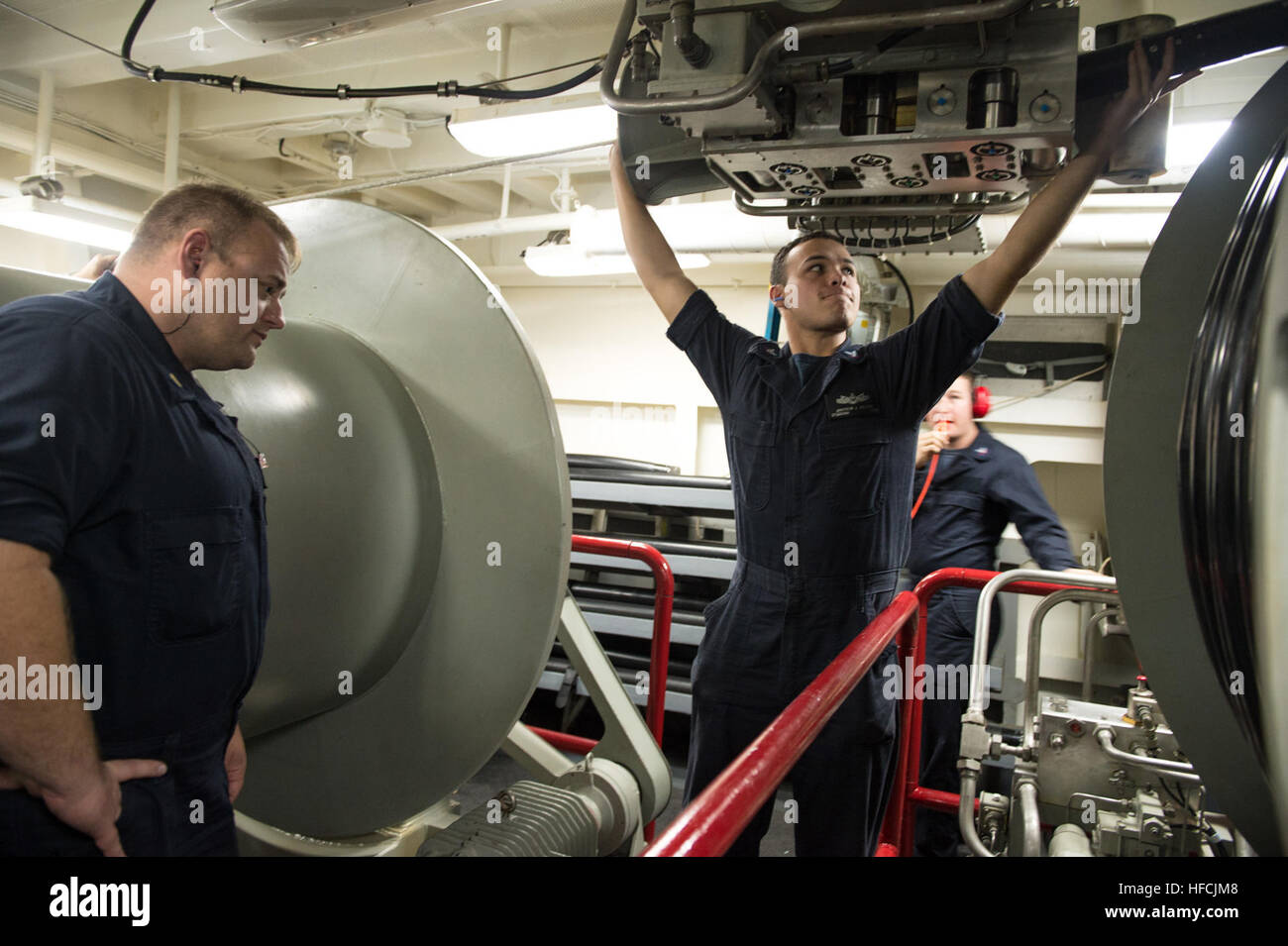Sailors aboard USS Donald Cook (DDG 75) draw out the nixie system as ...