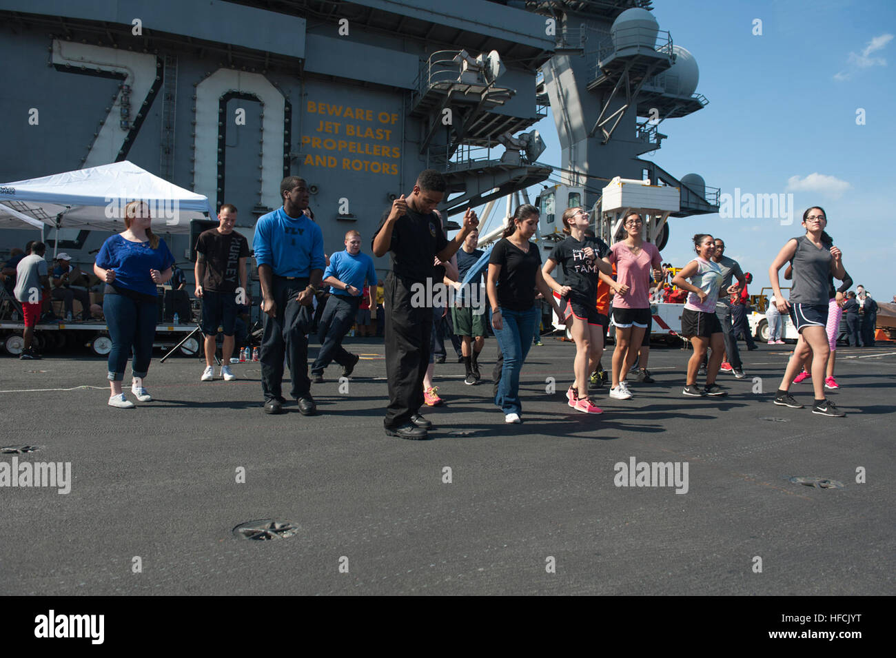 Sailors dance during a steel-beach picnic on the flight deck of the ...