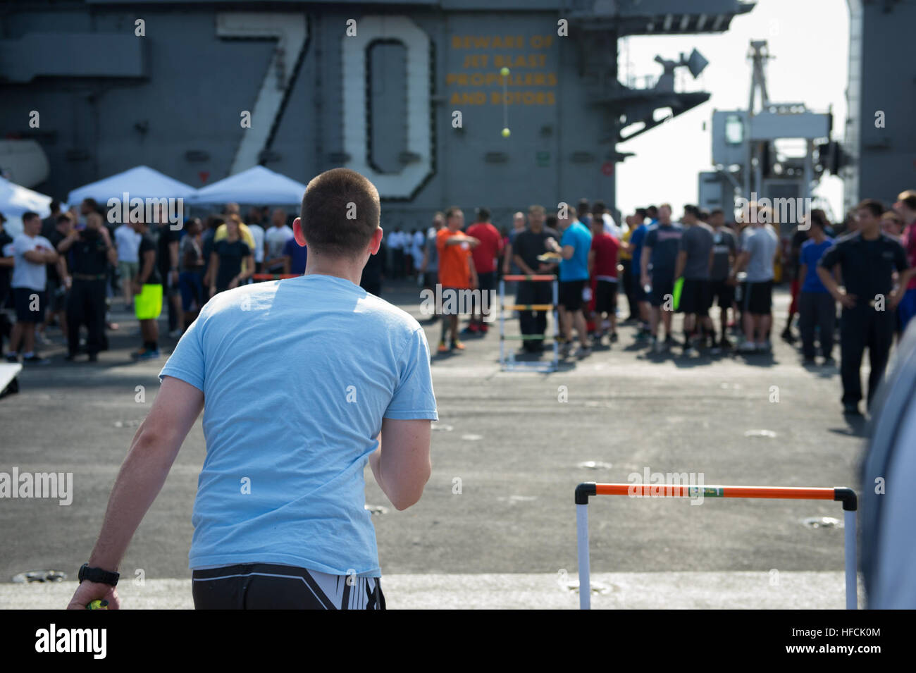 Sailors play a game of bolo toss during a steel beach picnic on the ...
