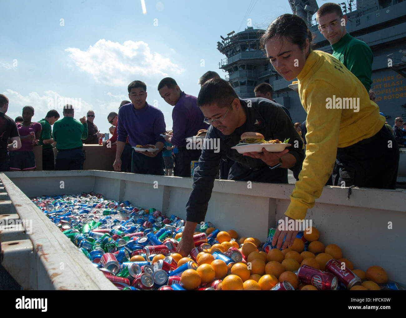 Sailors grab drinks during a steel-beach picnic on the flight deck of ...
