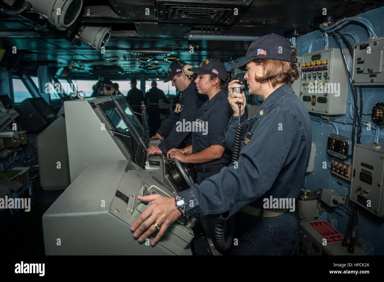 Sailors participate in a steering excrcise on the bridge of the Nimitz ...