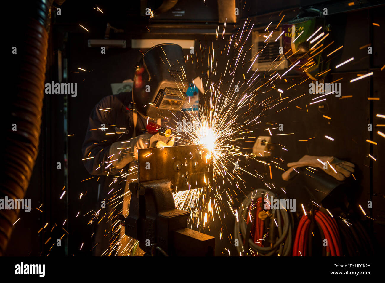 Damage Controlman 2nd Class Shane Rutherford practices using a portable ...