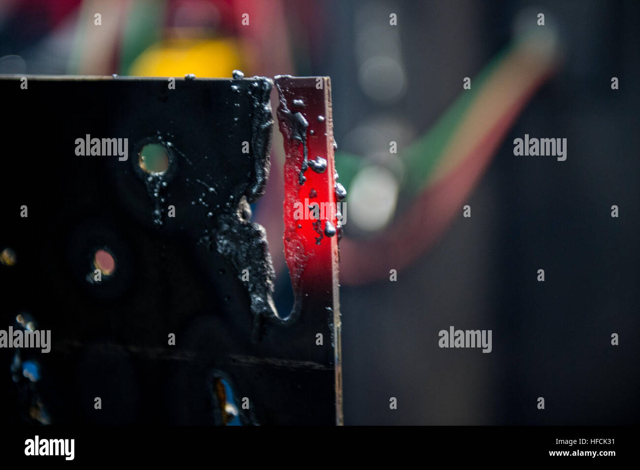 Damage Controlman 2nd Class Shane Rutherford practices using a portable ...