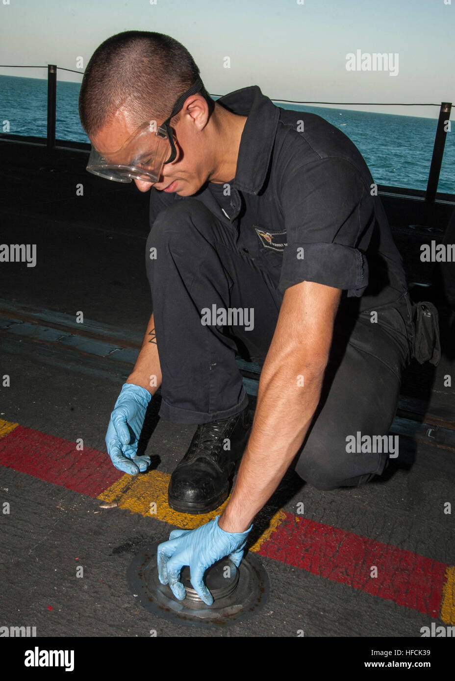 Seaman Robert Rodriguez performs a maintenance check in the hanger bay ...