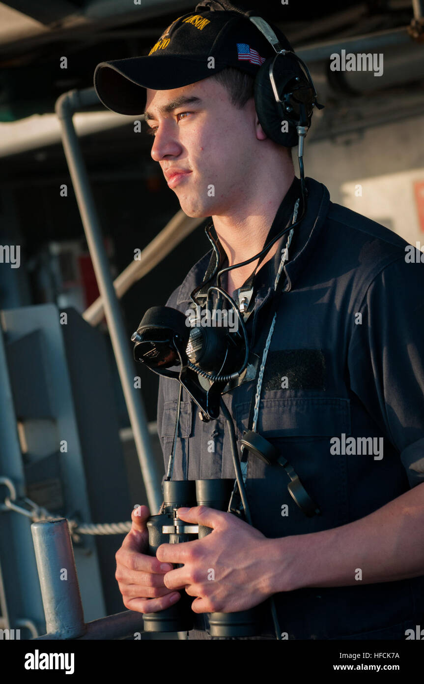 Seaman Alex Patterson stands watch on the fantail of the aircraft ...
