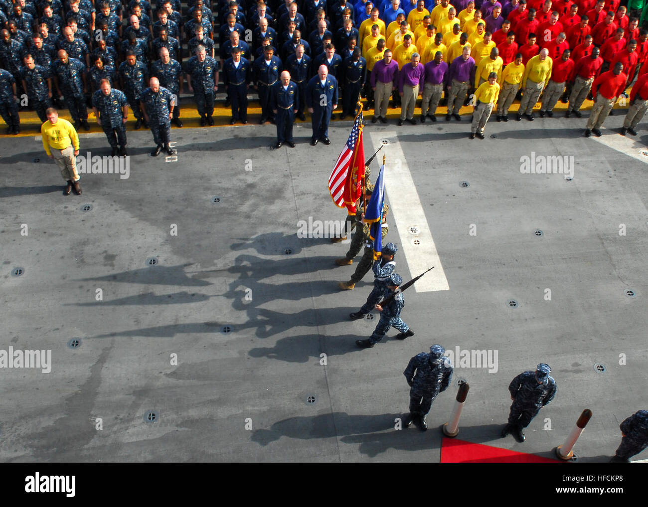 The color guard aboard the multipurpose amphibious assault ship USS Bataan parades the colors ...