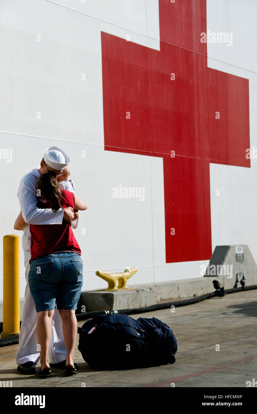 Ship's Serviceman 3rd Class Ethan Reifer embraces his wife and baby boy ...