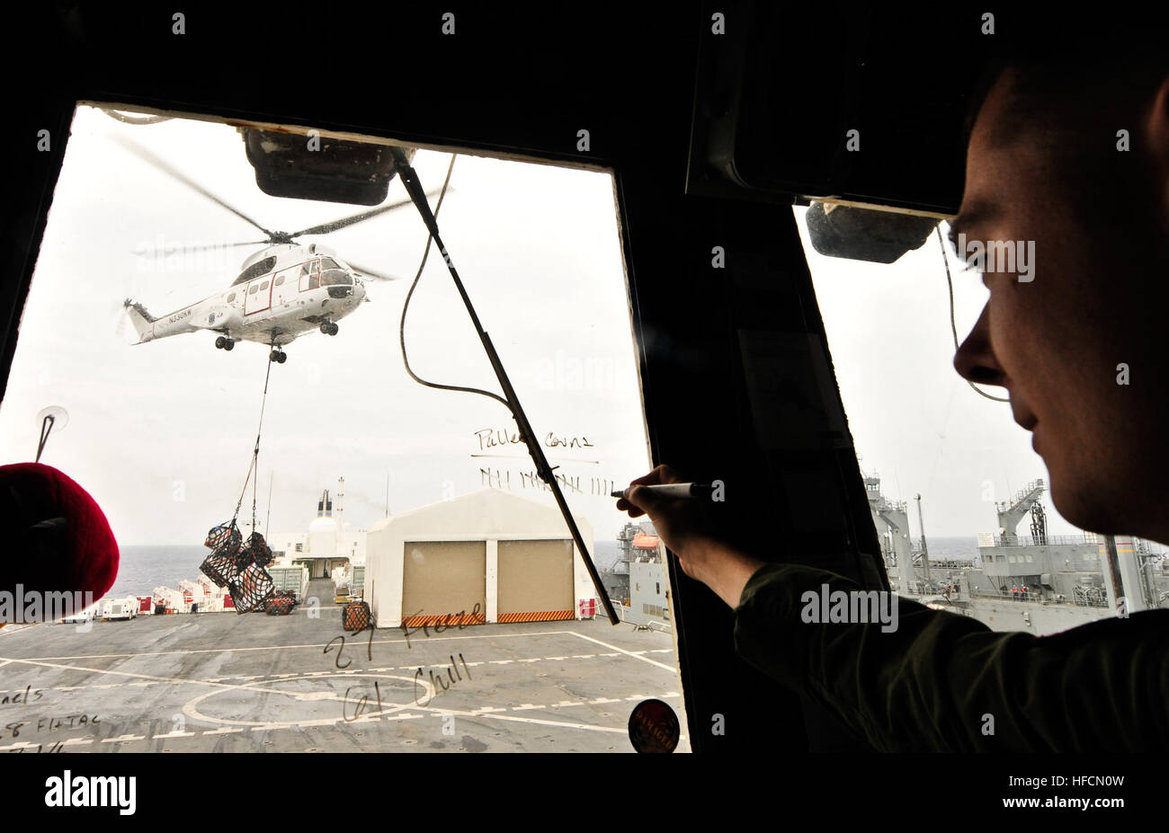 U.S. Navy Lt. Adam Boyd, with Helicopter Sea Combat Squadron 21, marks ...