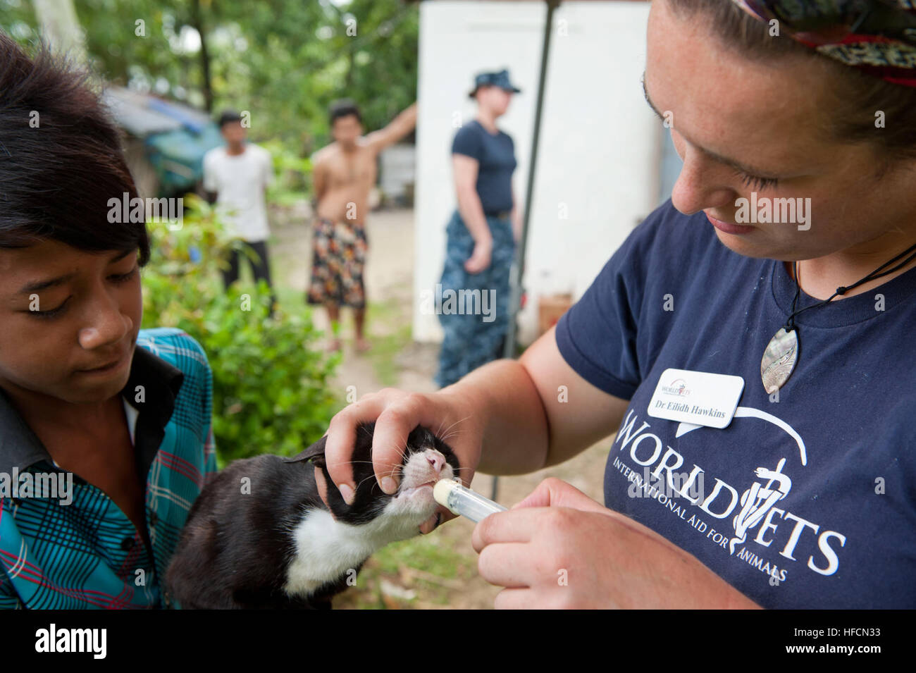 World Vets volunteer Eilidh Hawkins feeds worming medication to a ...