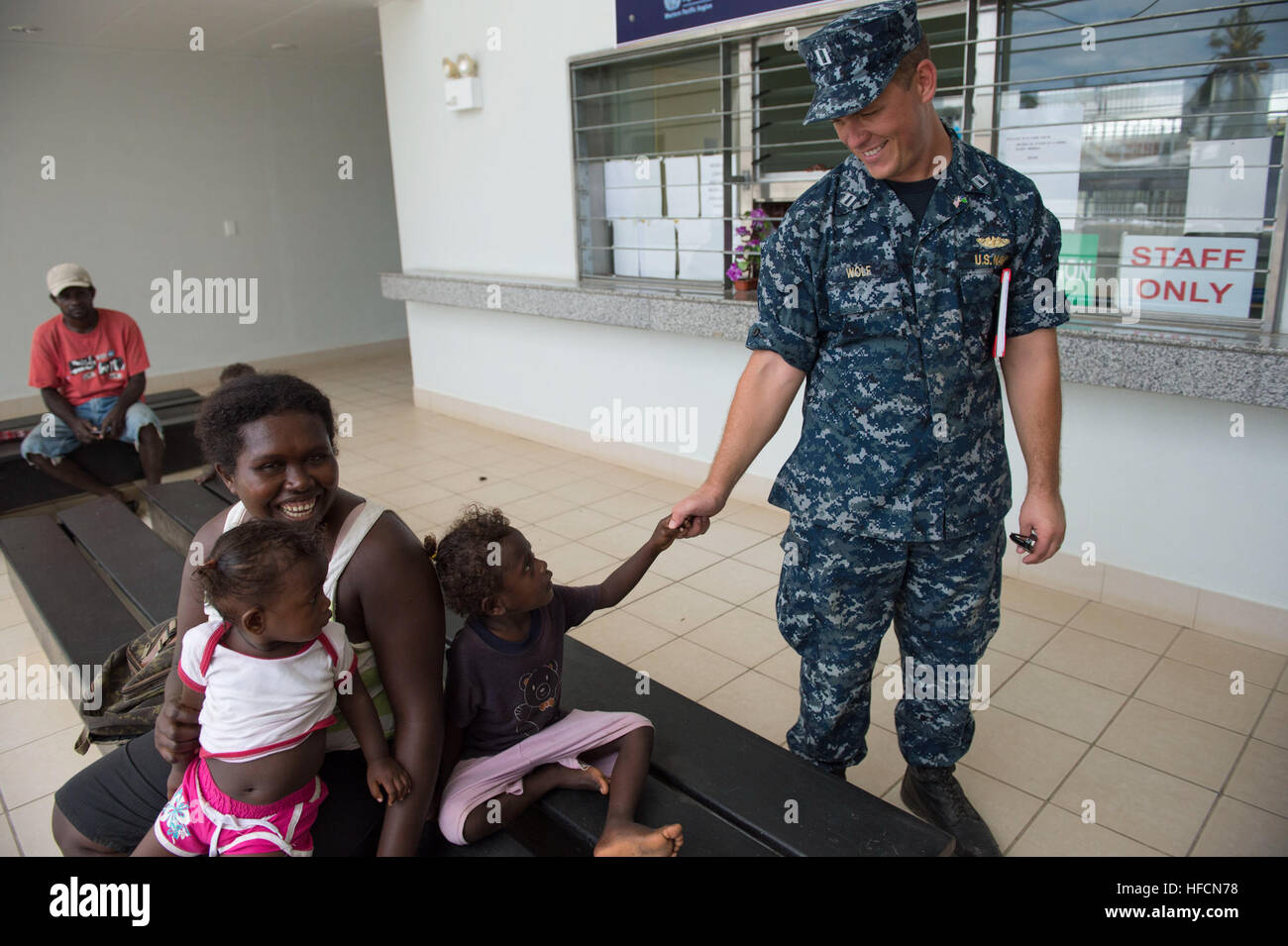 Lt. Luke Wolf shakes a child's hand while on a tour of Gizo Hospital ...