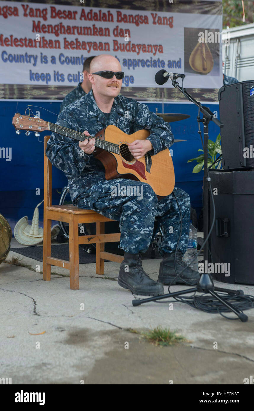 A U.S. Navy musician performs on guitar at a primary school in Rote ...