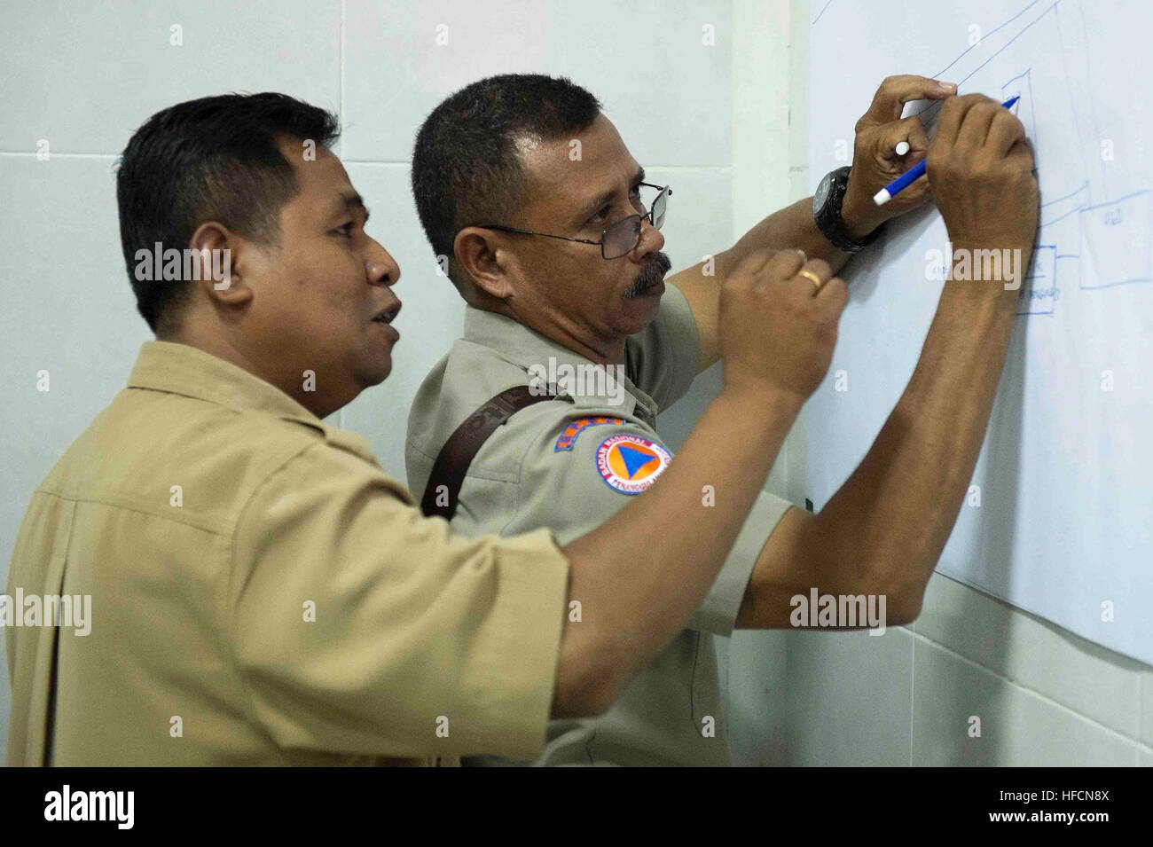 Indonesian emergency response team members discuss plans during a ...