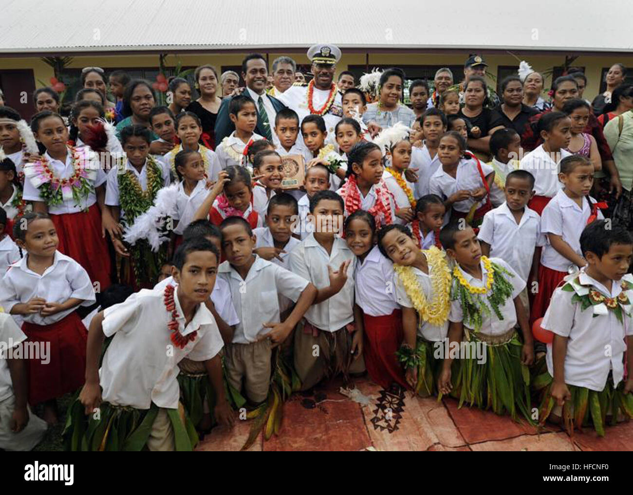 Capt. Jesse Wilson poses with staff and students at a primary school re ...