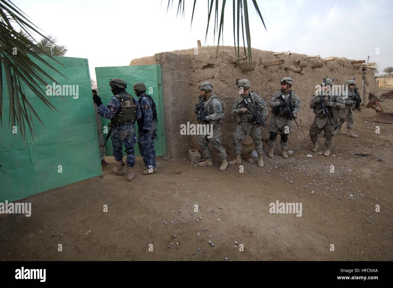 U.S. Soldiers follow Iraqi policemen into an Iraqi home. U.S. Soldiers ...