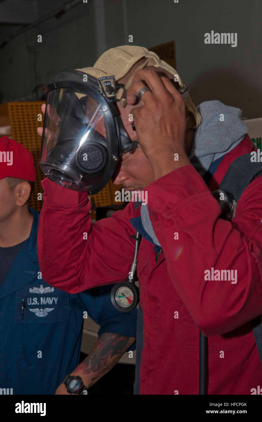 U.S. Navy Logistics Specialist Seaman Brandon Joyner dons an MCU-2/P ...