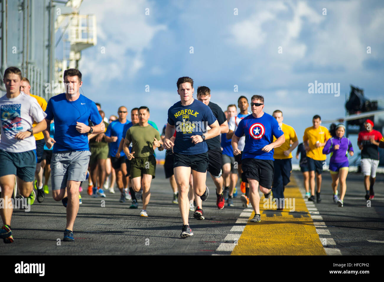 Sailors and Marines participate in a 5K run aboard the amphibious ...