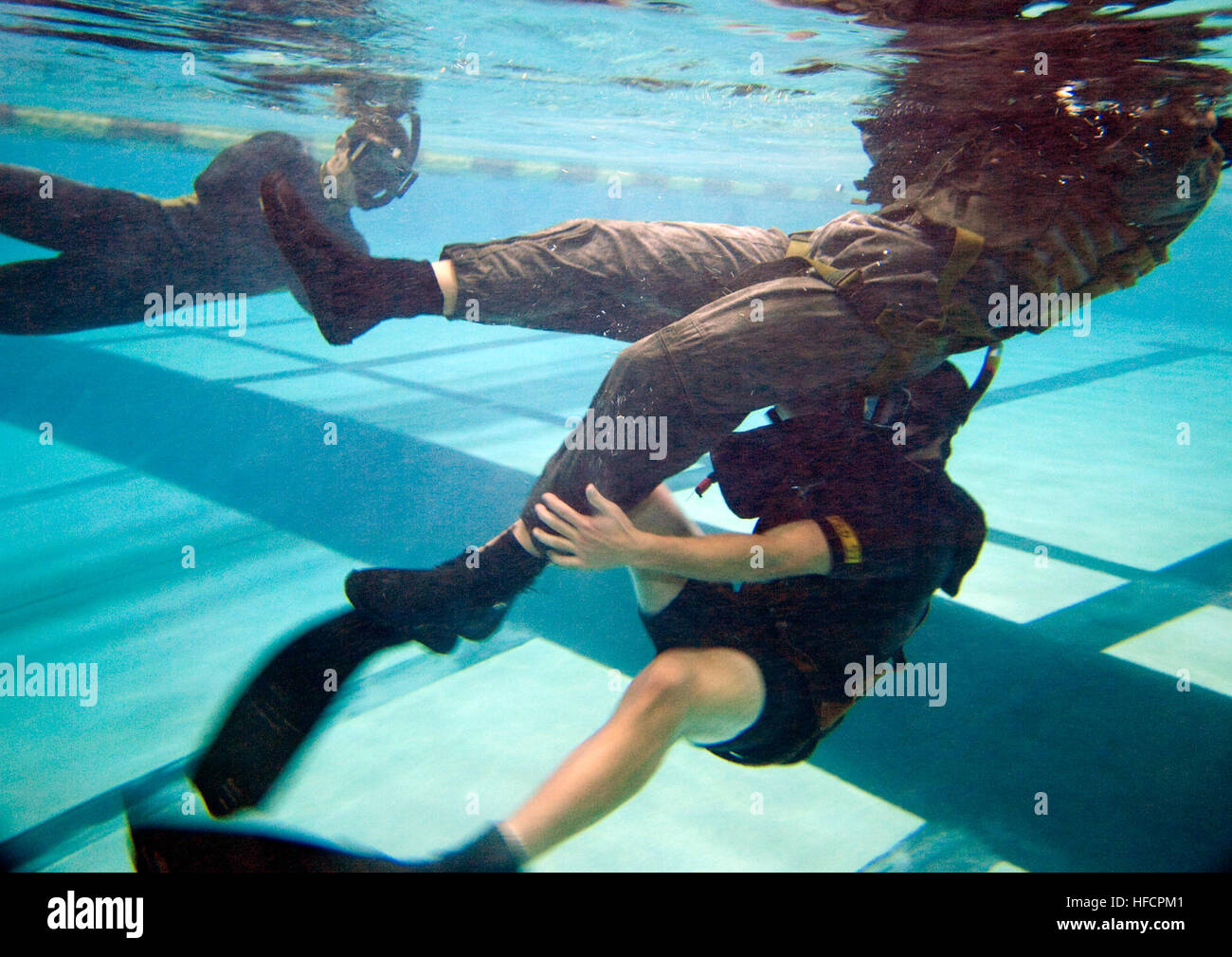 A Rescue Swimmer School candidate performs a body sweep to check for ...