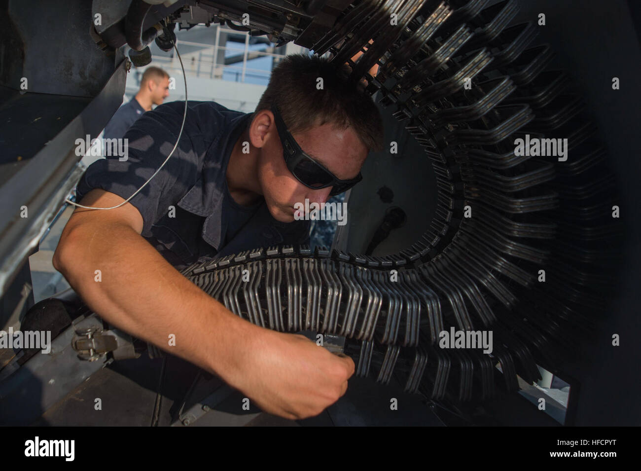 Gunner's Mate Seaman Jonathan Ward, from Forsyth, Ga., loads ammunition ...