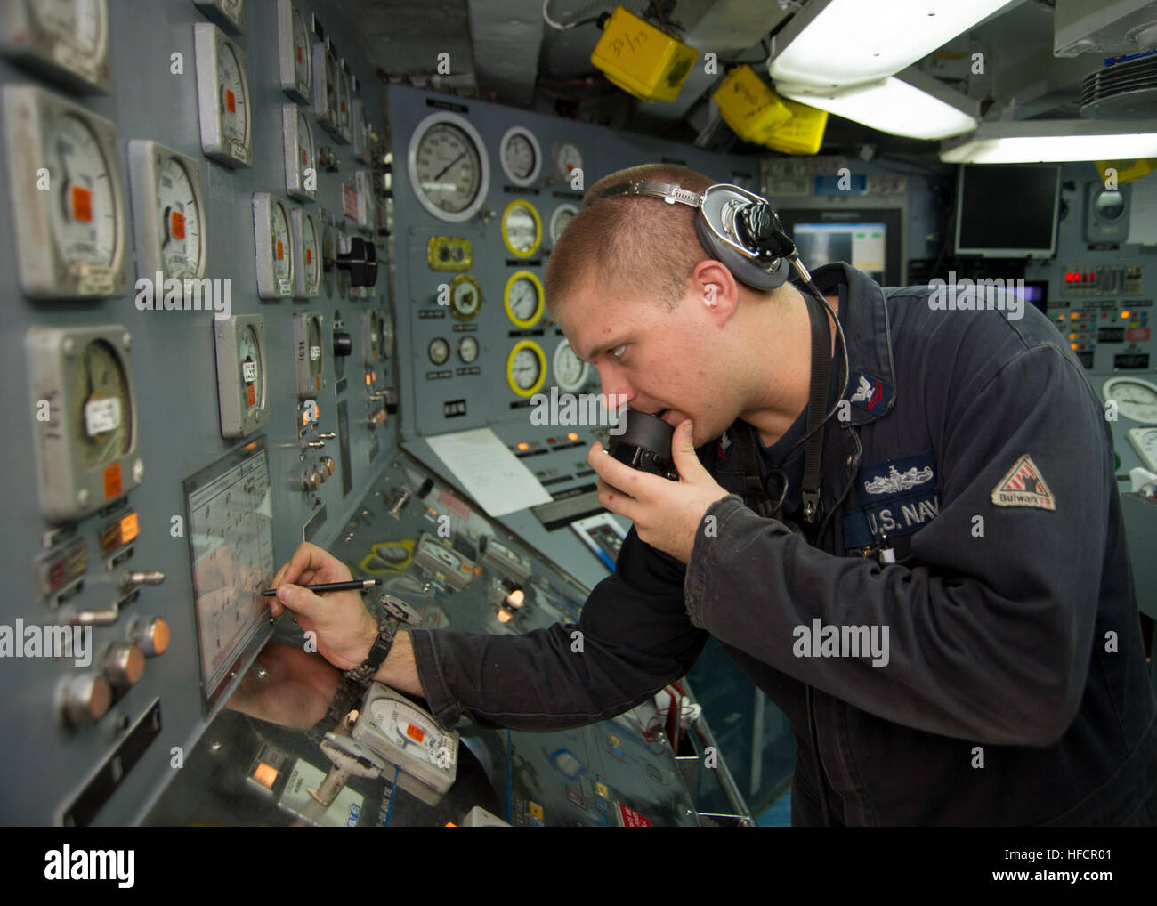 Electrician's Mate 2nd Class Thomas Criddle monitors the amperage of ...