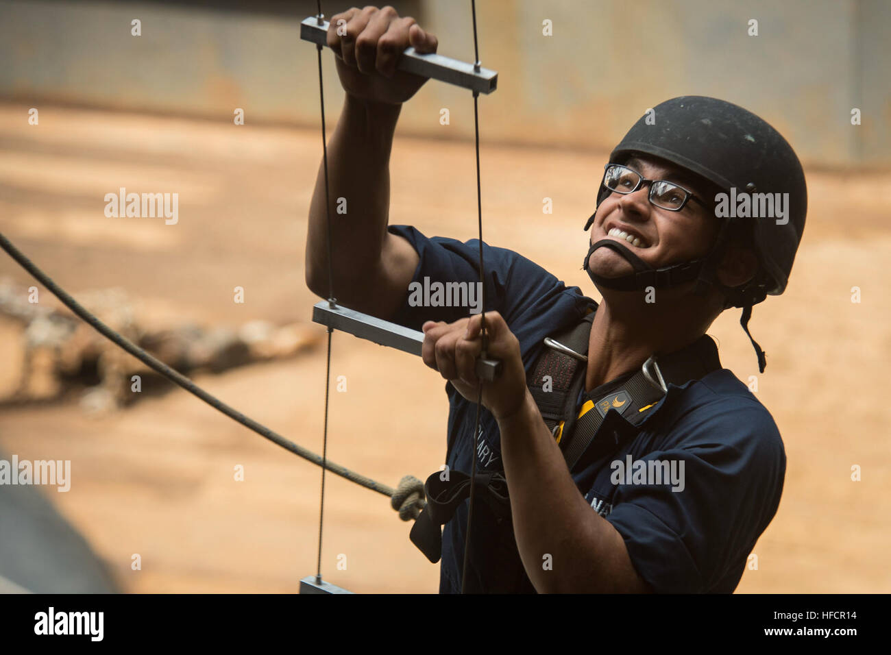 Boatswain's Mate Seaman Shaquille Clary, from Gastonia, Ga., climbs a ...