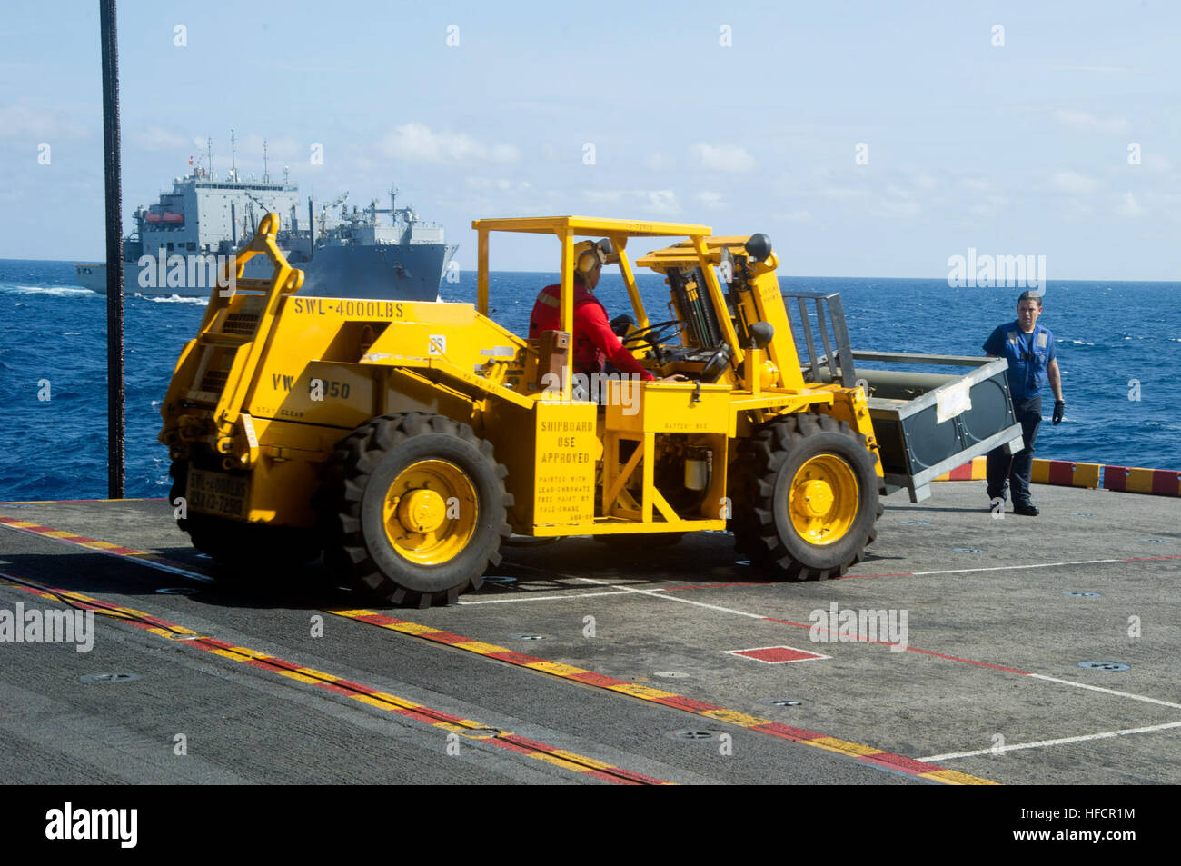 U.S. Navy Aviation Ordnanceman 3rd Class Michael Ellis uses a forklift ...