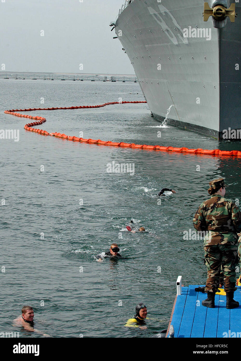Sailors complete the swimming part of a physical training challenge at ...