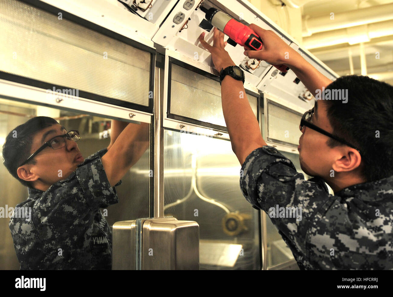 Electrician's Mate Fireman Apprentice John Christian Palmiano installs ...