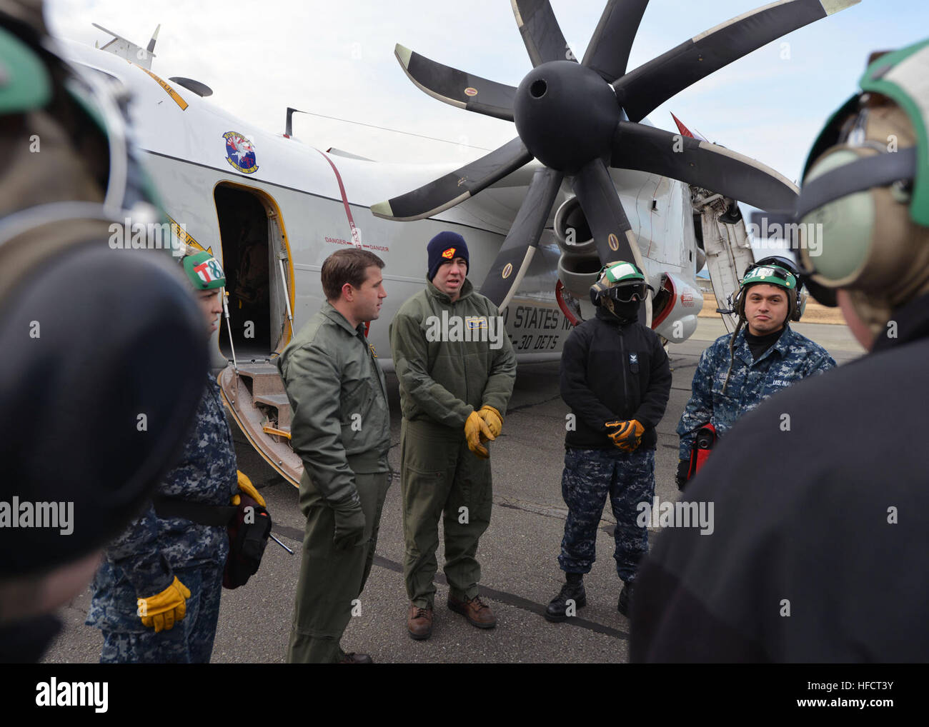 Fleet Logistics Support Squadron (VRC) 30 Det. 5 Sailors huddle on the ...