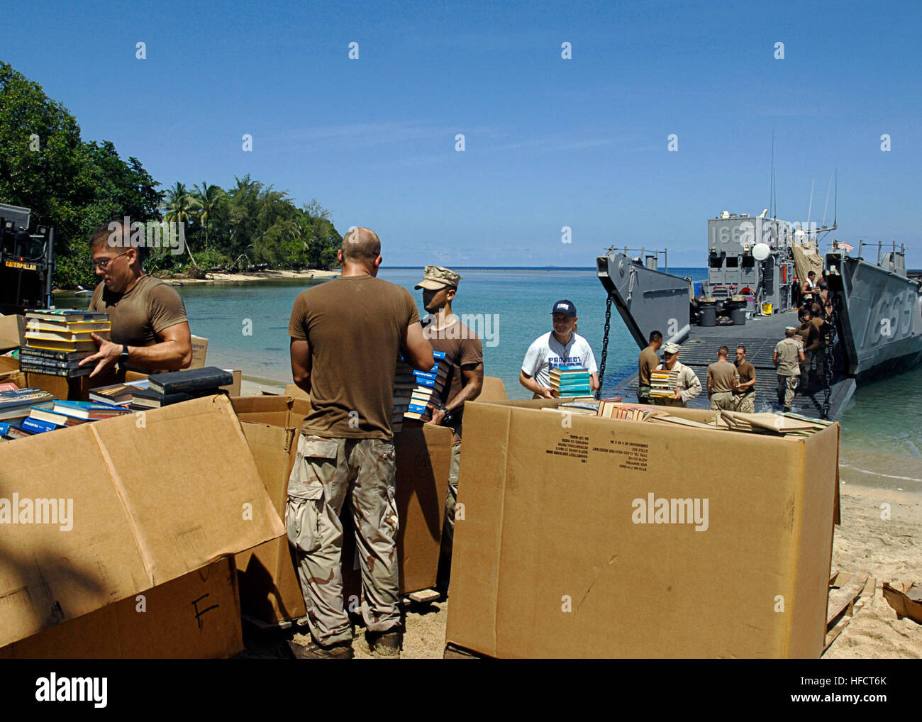 Seabees attached to Amphibious Construction Battalion (ACB) 1, unload ...