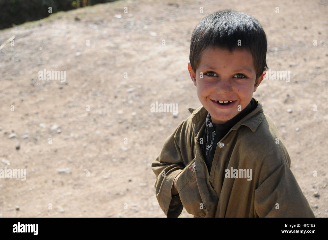 An Afghan boy poses for a photo outside the Bala Boluk district center ...