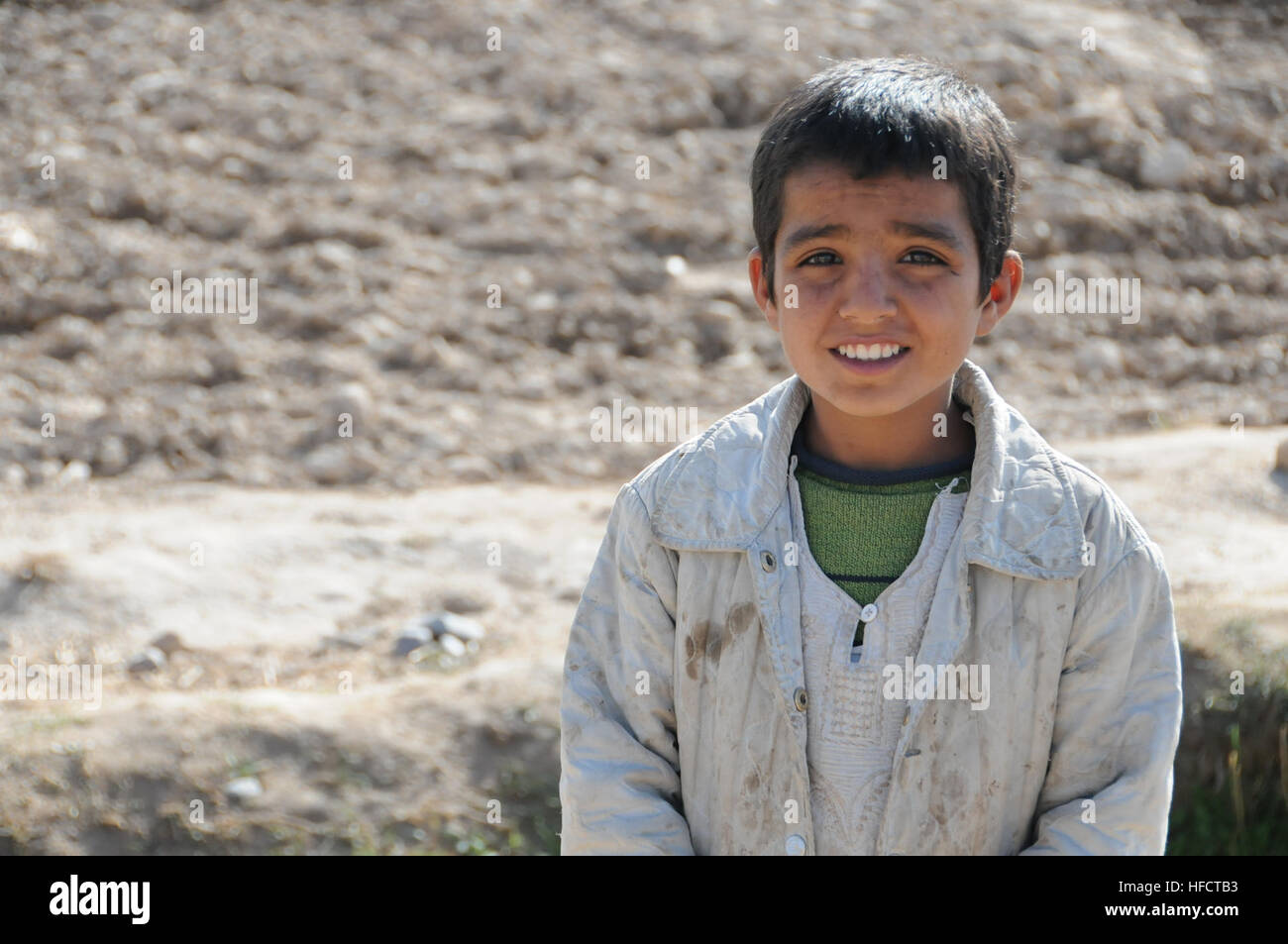 An Afghan boy poses for a photo outside the Bala Boluk district center ...