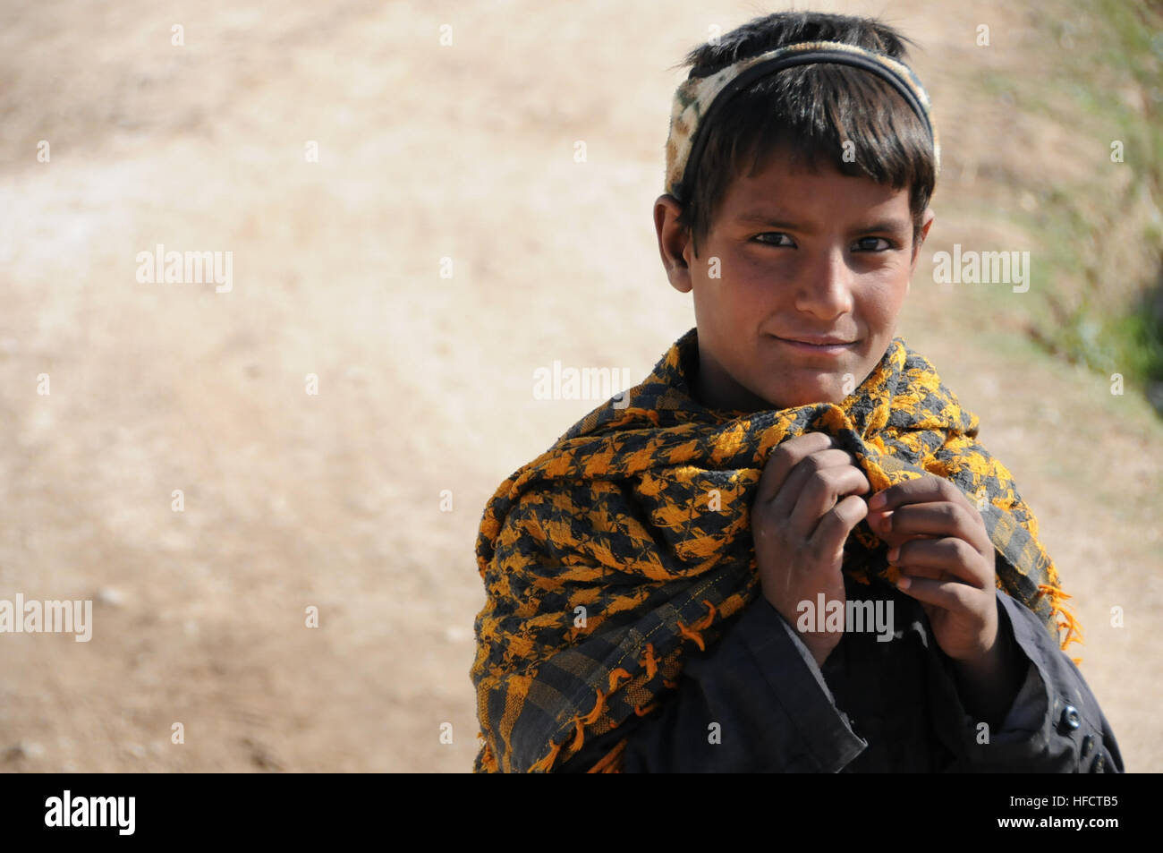An Afghan boy poses for a photo outside the Bala Boluk district center ...