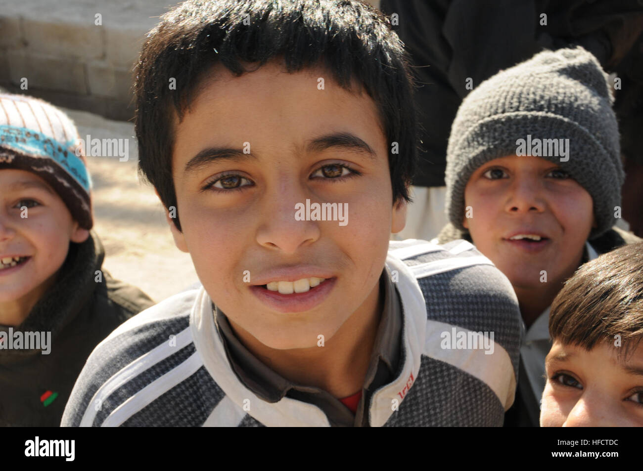 An Afghan boy poses for a photo on the street outside a key leader ...