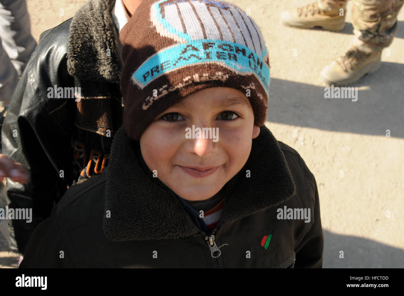 An Afghan boy poses for a photo on the street outside a key leader ...