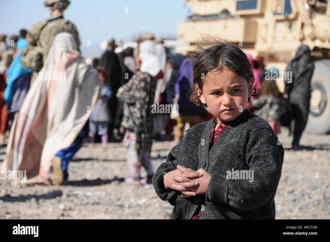 A young Farahi girl waits patiently to receive assistance during a ...