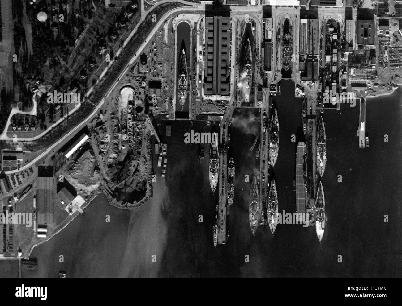 Aerial view of Puget Sound Naval Shipyard showing ship berths, dry ...