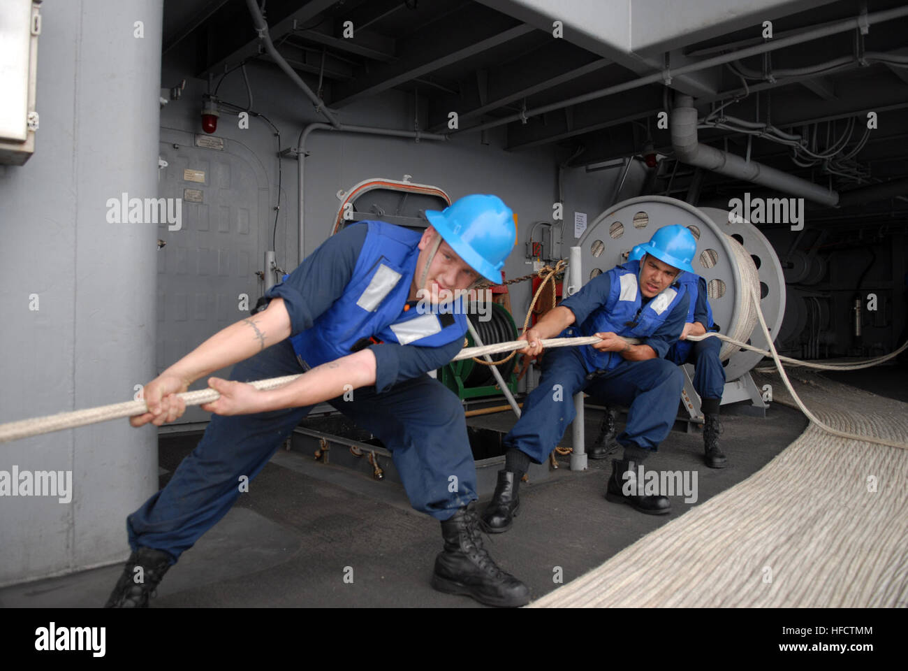 Petty Officer 3rd Class Andrew Horner and Seaman Willie Perry lean ...