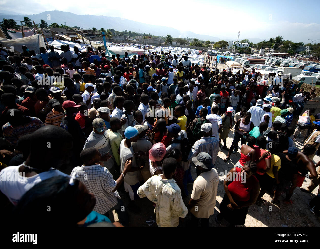 Haitian earthquake survivors gather at a Red Cross distribution site in ...