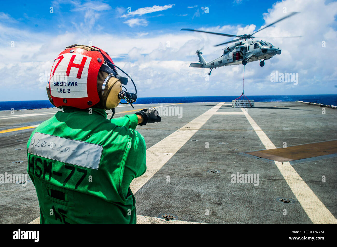 U.S. Navy Aviation Electrician's Mate 3rd Class Edder Ramos signals the ...