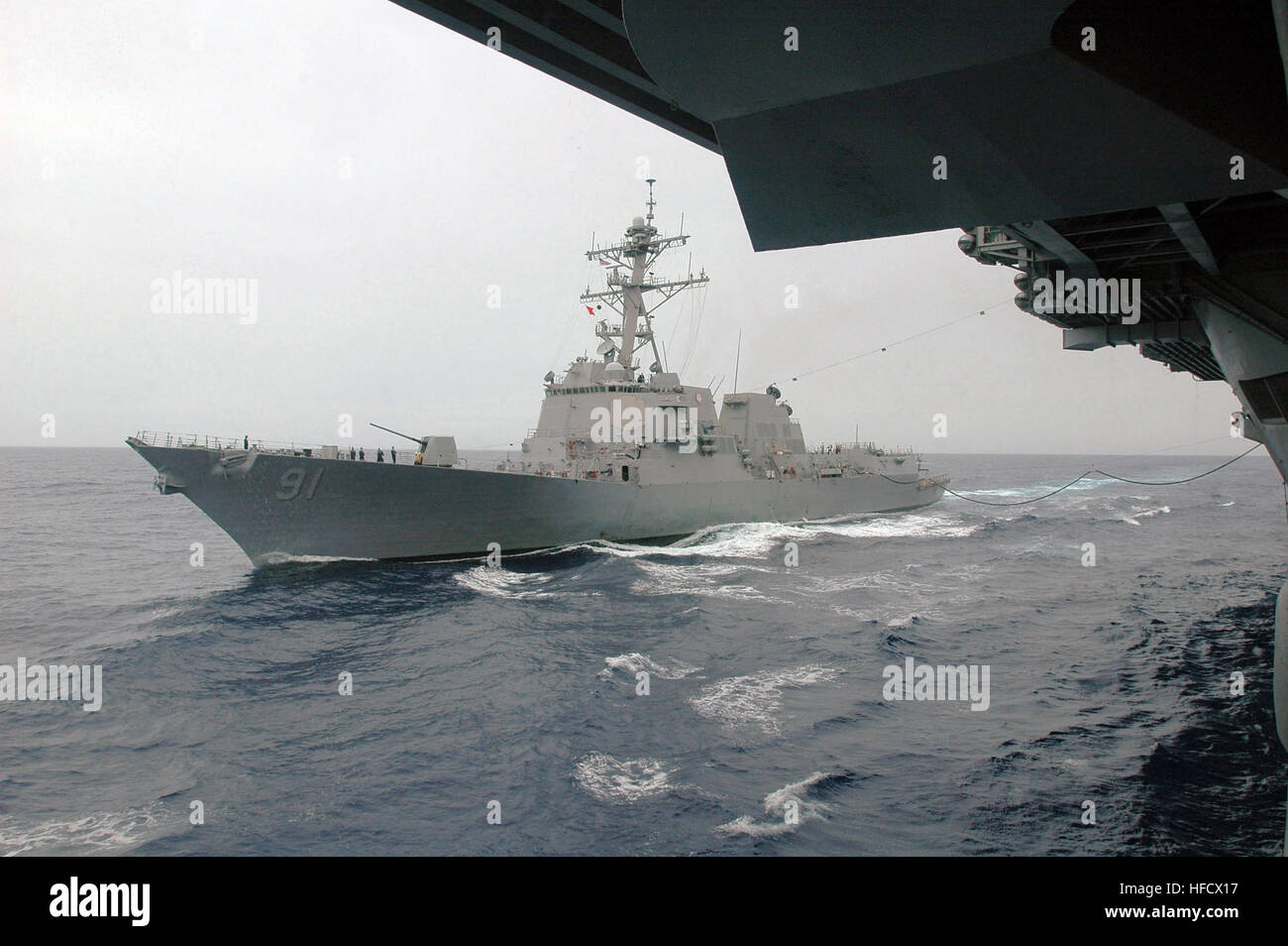 USS Pinckney (DDG 91) performs an underway replenishment with aircraft ...