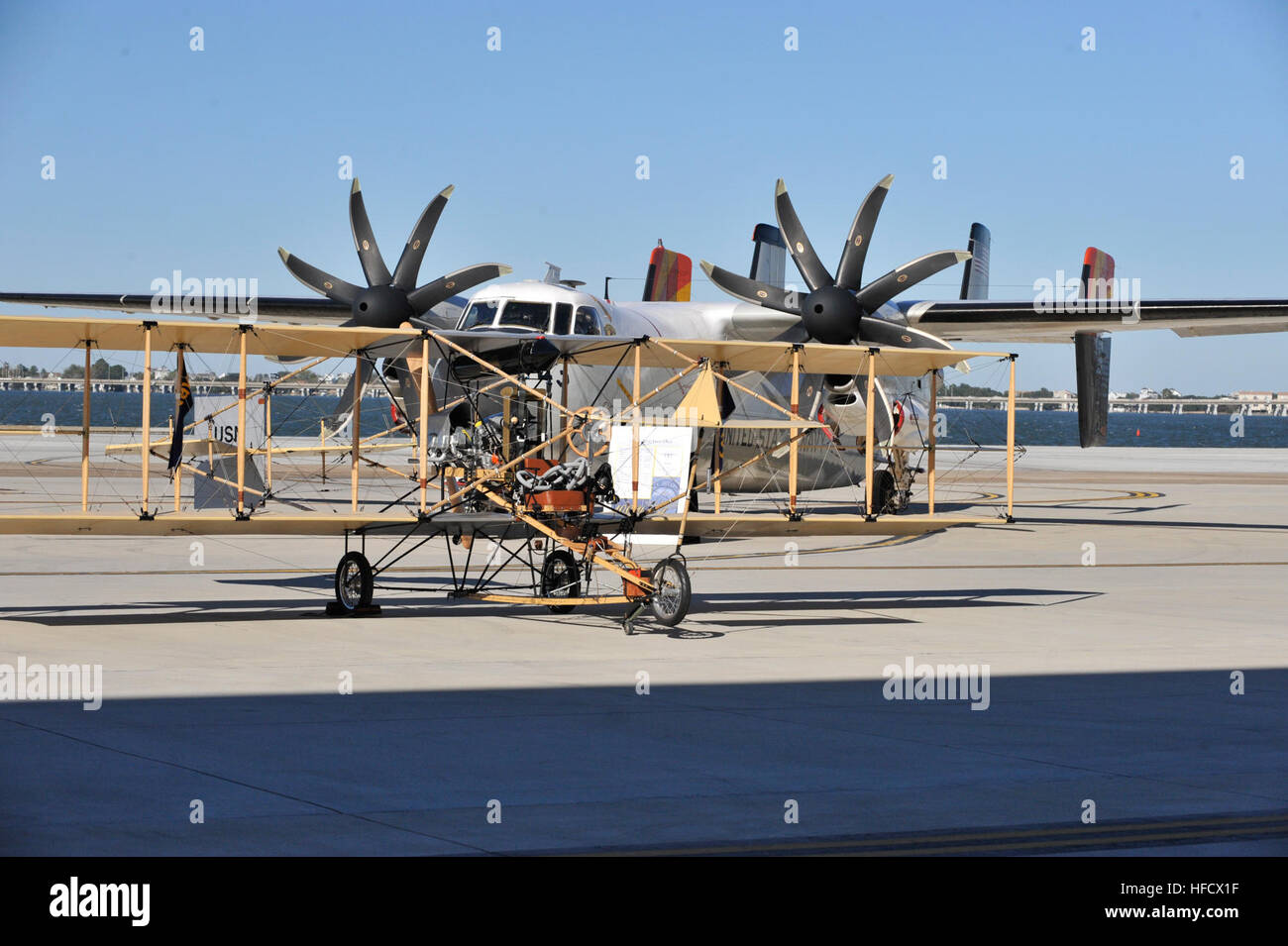A replica Curtiss bi-plane is displayed in front of a C-2A Greyhound at ...