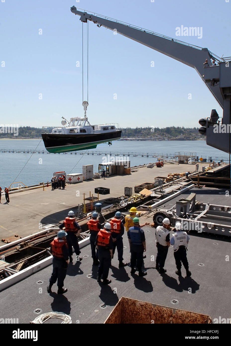 Members of deck department work to bring the Commander, Carrier Strike ...