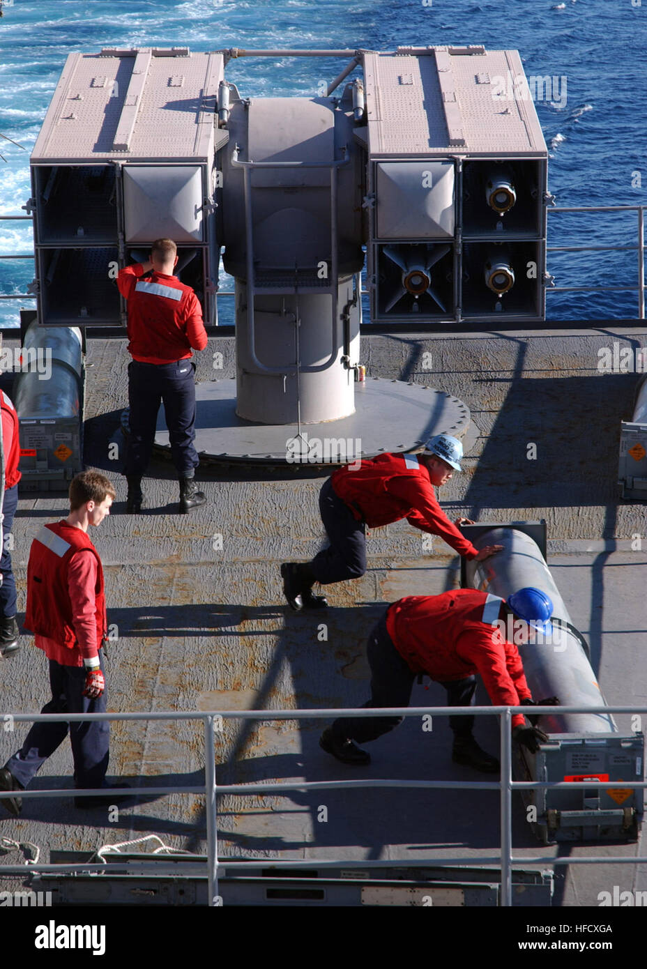 Fire controlmen off-load AIM-7 NATO Sea Sparrow missiles from a ...