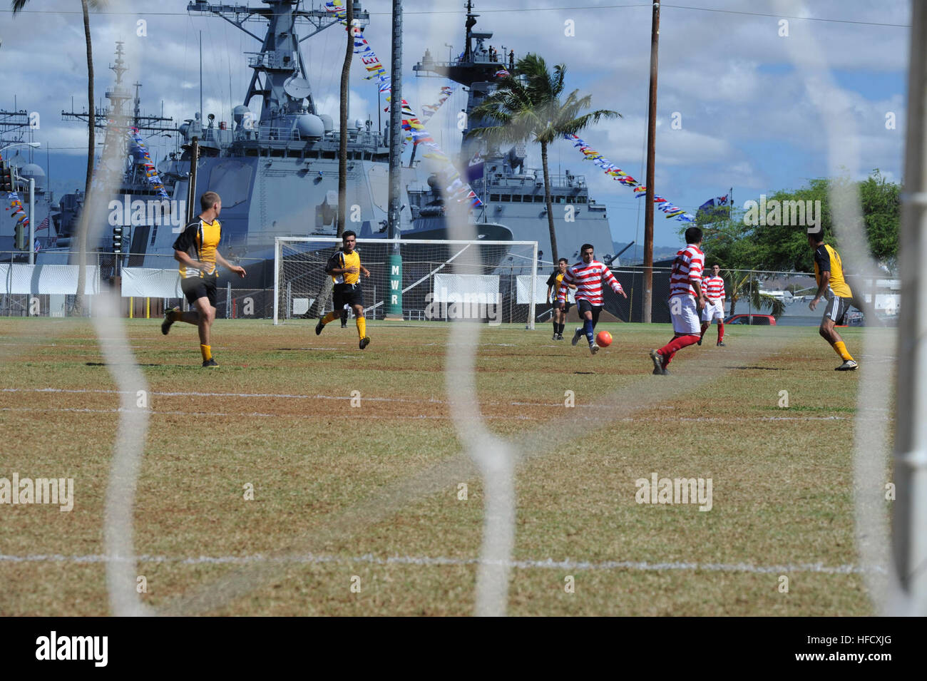 U.S. Navy sailors aboard USS Paul Hamilton engaged in a soccer match ...