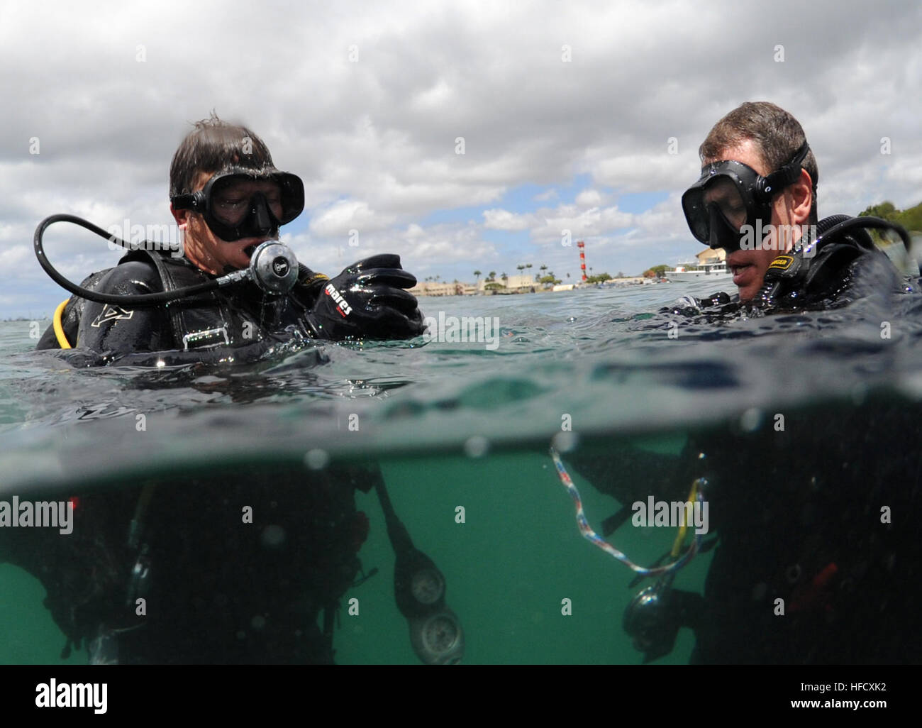 Royal Australian Navy divers prepare to begin a familiarization dive ...