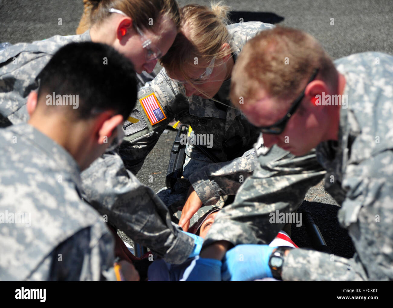 A role player made up as a disaster victim receives medical care from ...