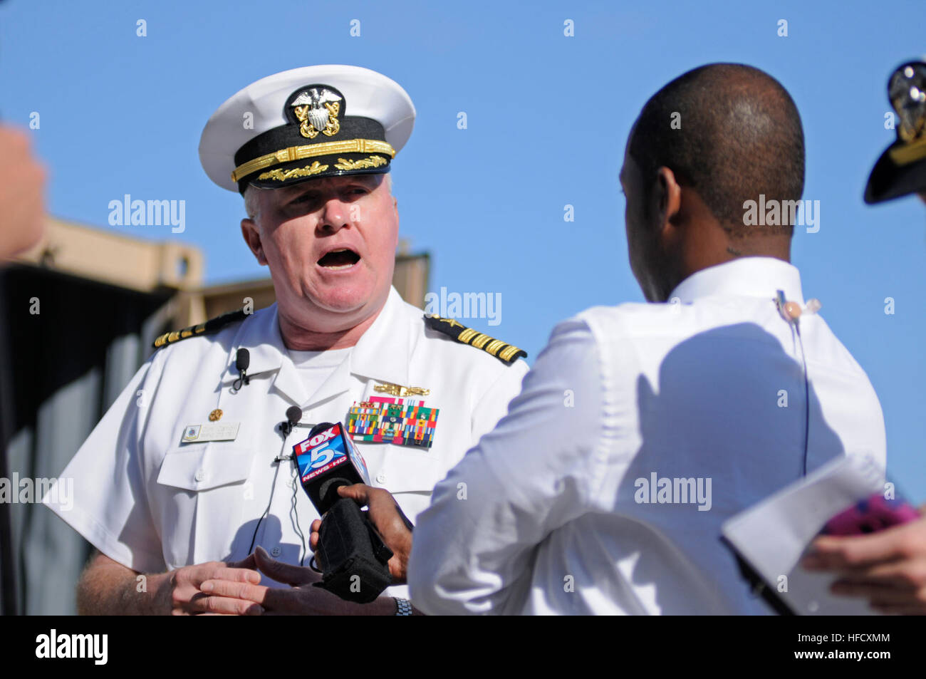 Capt. Clint Caroll, commander, Amphibious Squadron (CPR) 3, talks to a ...
