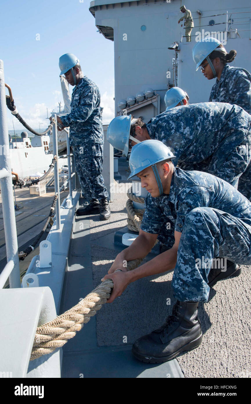 U.S. Sailors heave mooring lines aboard the dock landing ship USS ...