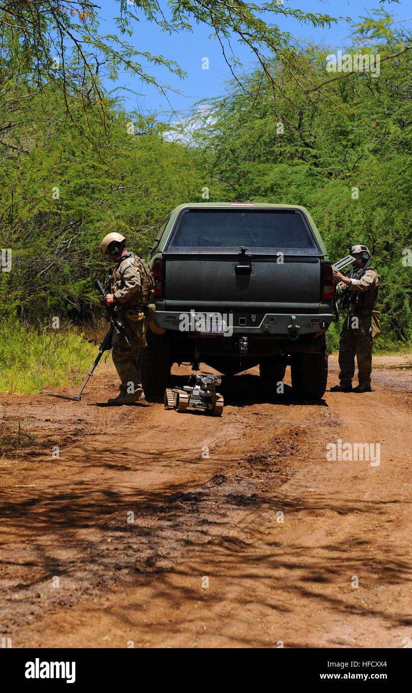 U.S. Navy explosive ordnance disposal (EOD) technicians use metal ...